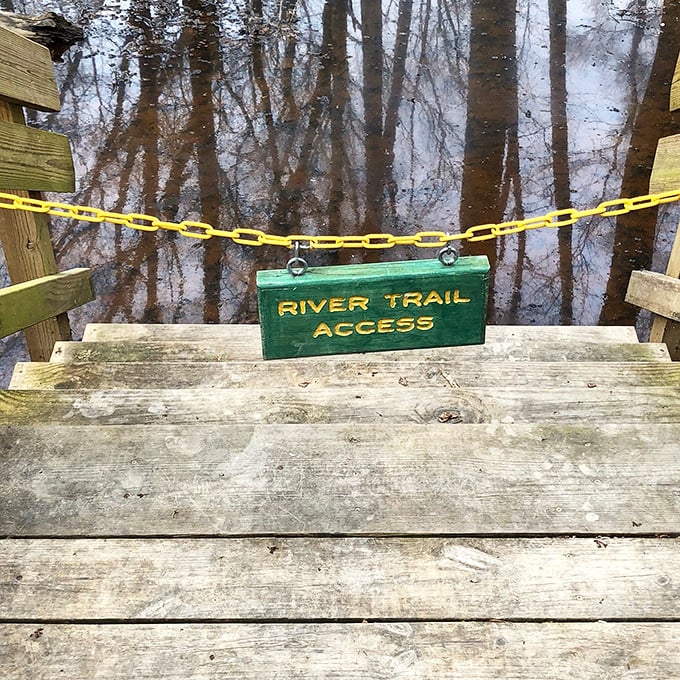 "River Trail Access" &ndash; three words that promise adventure, serenity, and possibly wet socks if you ignore that yellow chain.