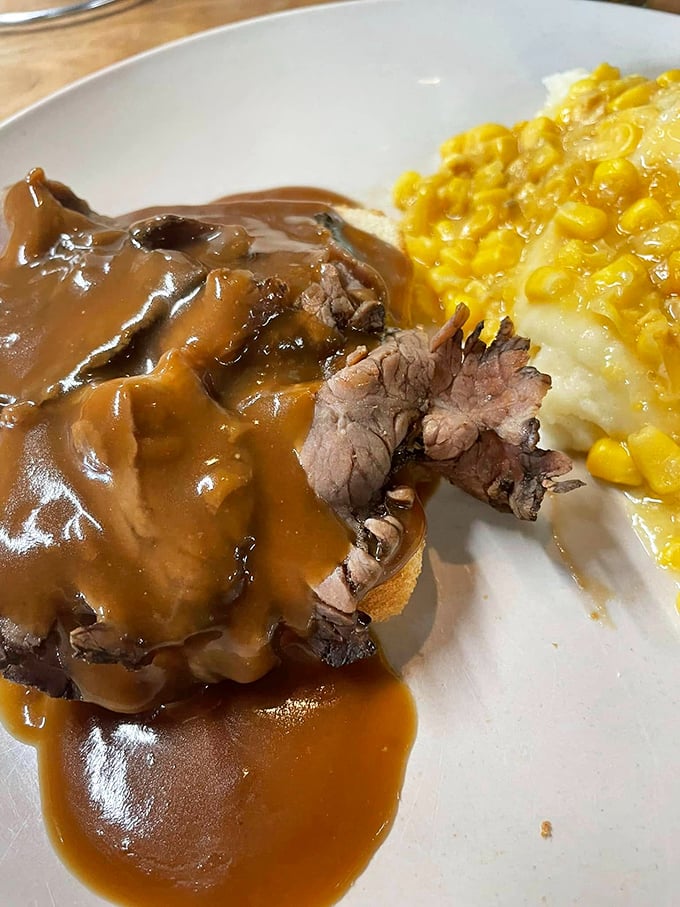 Roast beef swimming in gravy alongside creamed corn&mdash;a plate that whispers "take a nap afterward" with every savory, comforting bite.