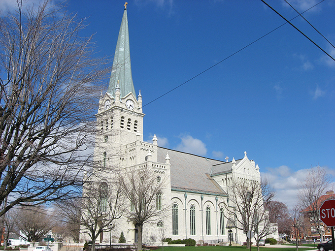 St. John's Catholic Church stands like a limestone sentinel over Delphos, its spire reaching skyward with architectural ambition that would impress even European visitors.