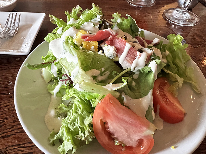 A salad that actually excites &ndash; fresh greens, ripe tomatoes, and what appears to be prosciutto playing the role of "not just another boring salad."