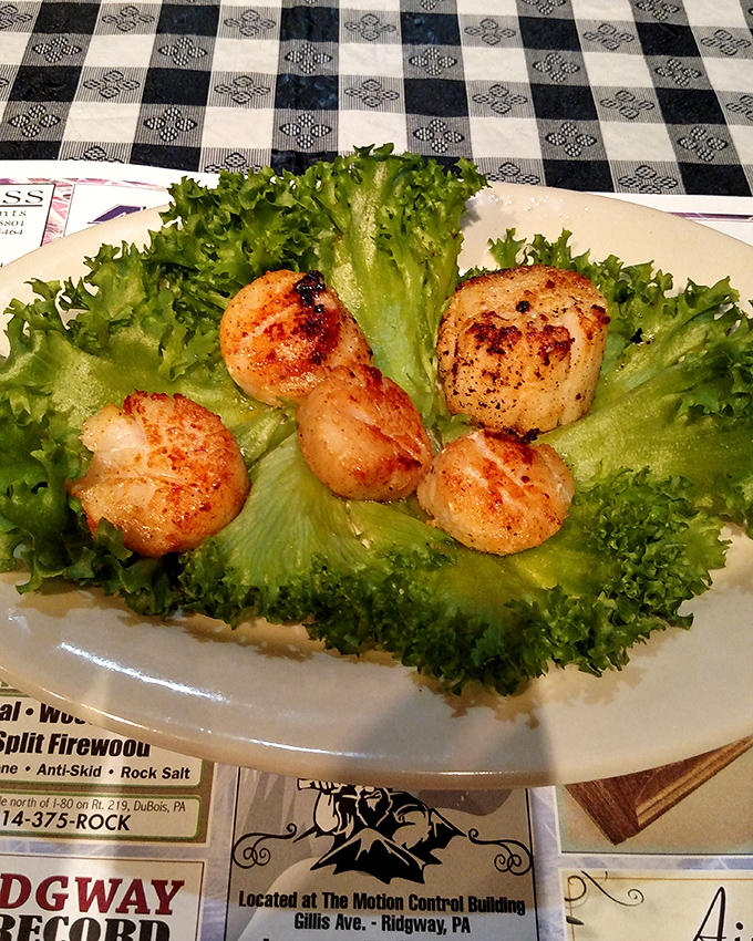 Perfectly seared scallops nestled on a bed of fresh greens. These golden-brown treasures of the sea prove The Summit excels beyond beef.