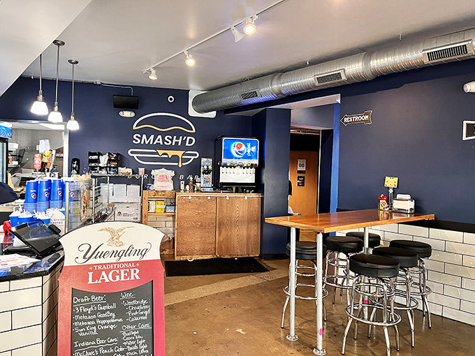 The service counter area reveals the beating heart of burger artistry. Those draft beer taps stand ready like firefighters waiting for the alarm to sound.
