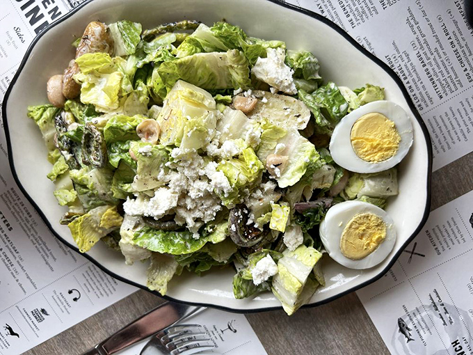A salad that's trying to convince you it's as satisfying as the skillets. And you know what? With those eggs and that dressing, it's making a compelling case.