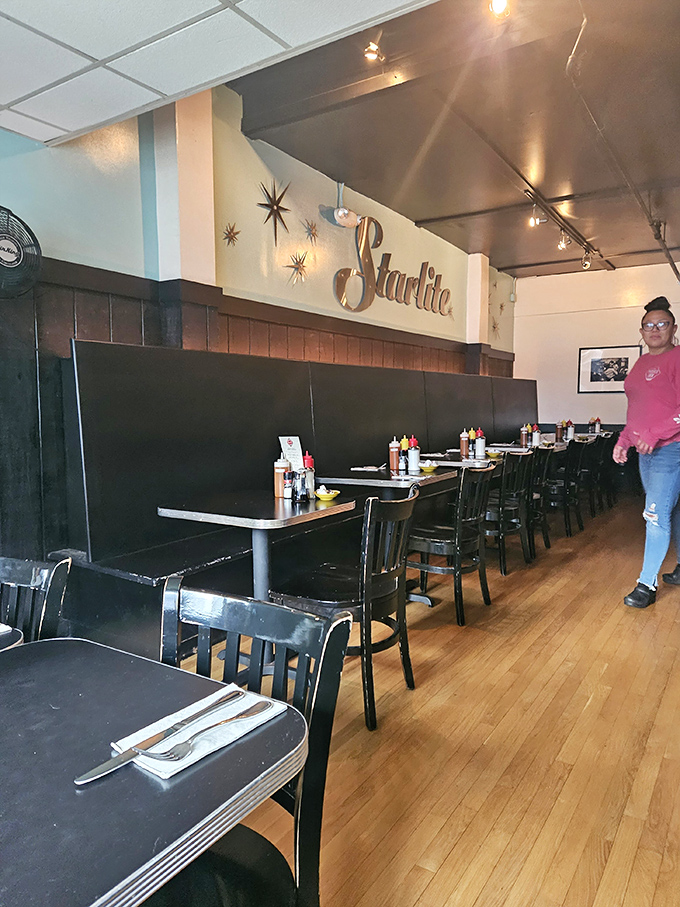 The dining room where retro meets refined. Those starburst decorations on the wall aren't just design elements&mdash;they're forecasting the flavor explosions to come.