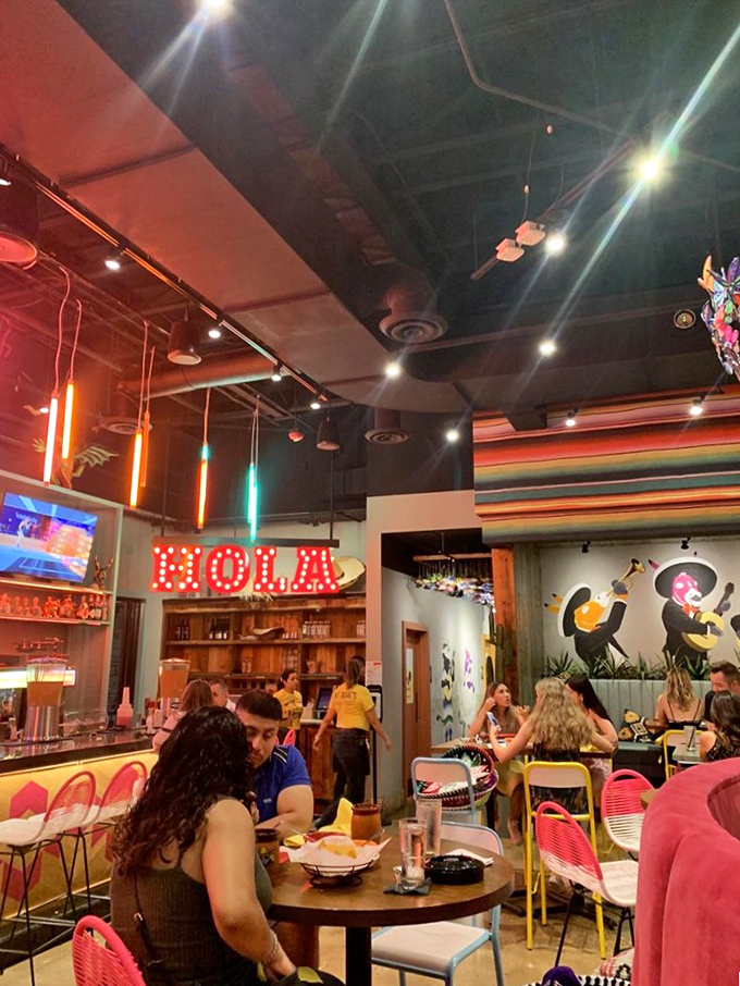The "HOLA" sign isn't just decor&mdash;it's a promise of the hospitality that awaits. Colorful lighting sets the perfect mood.
