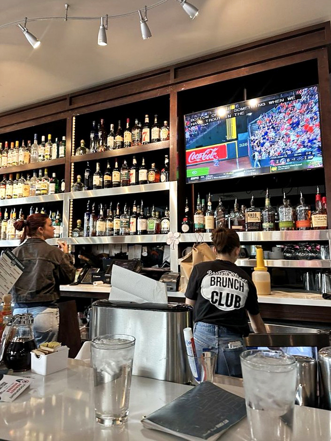 Behind the bar, where brunch magic happens and staff shirts proudly declare allegiance to the most important meal of the day.