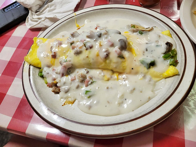 An omelet smothered in country gravy&mdash;where breakfast meets comfort food in a glorious union that makes you question why we don't eat this way every day.
