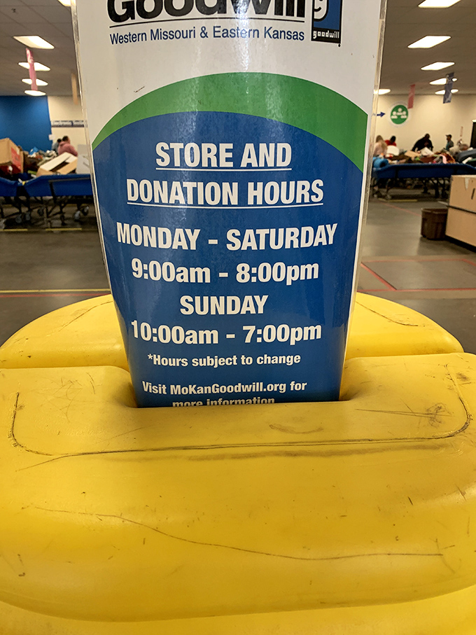 The hours of operation sign perched atop a yellow cushion&mdash;essential information for planning your next bargain expedition.