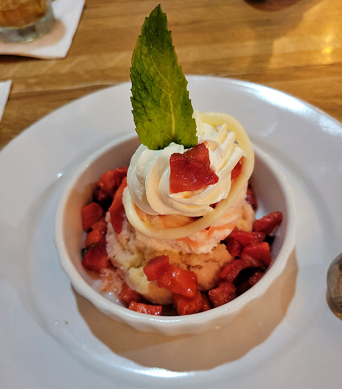 Strawberry dessert that looks like summer decided to throw a party in a bowl. That mint leaf isn't just garnish—it's wearing a tiny green tuxedo.
