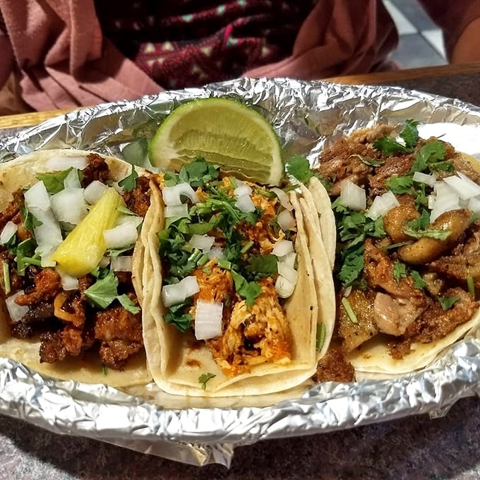 Three tacos that tell different stories&mdash;each one topped with the classic combination of cilantro, onion, and a squeeze of lime that whispers, "authenticity lives here."