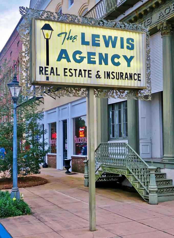The Lewis Agency sign hangs like a time capsule from an era when insurance agents were local celebrities and real estate was discussed over coffee.