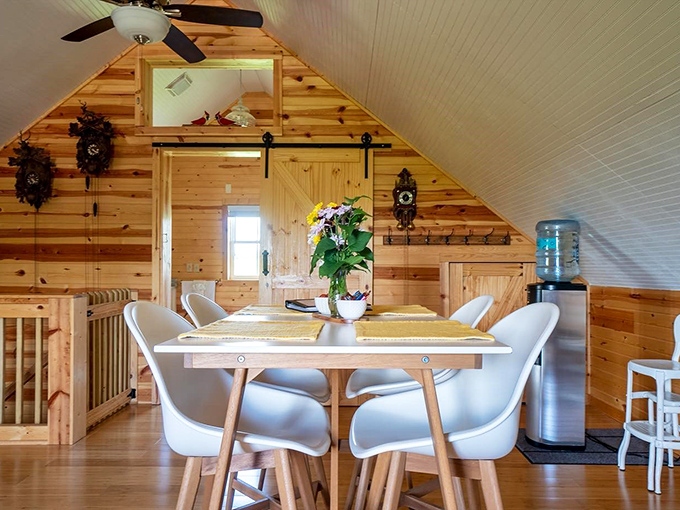 Modern meets rustic in this airy loft space. The sliding barn door says "farmhouse chic," but the Scandinavian-style dining set whispers "sophisticated palate."
