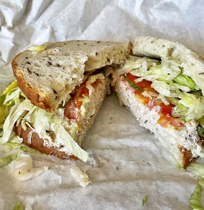This isn't your sad office lunch tuna sandwich&mdash;it's a proper deli creation with crisp lettuce and tomato on bread that actually has flavor.