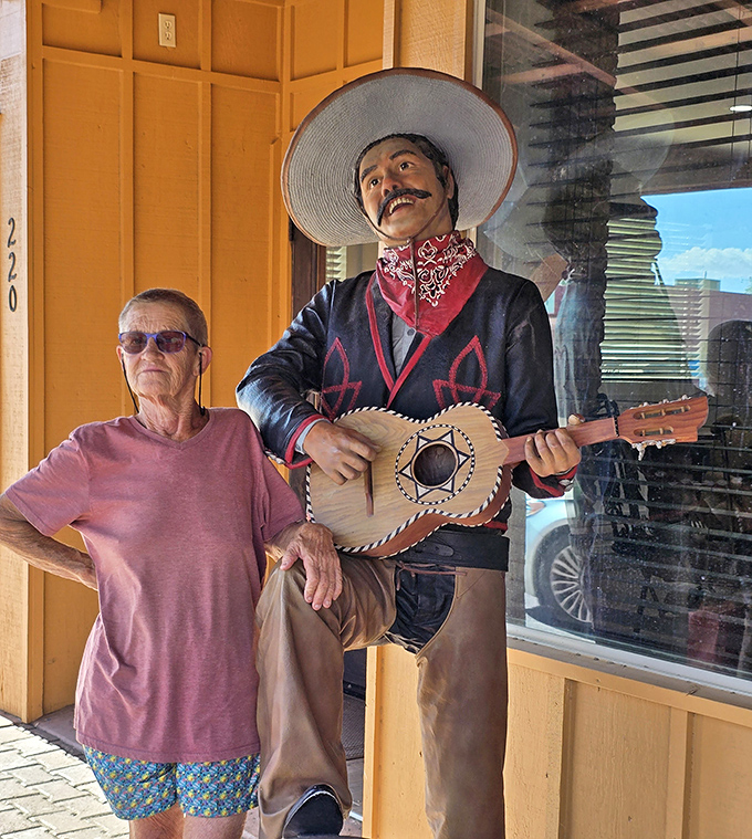 This guitar-strumming vaquero statue stands guard outside, silently promising authentic Southwestern flavor before you even reach the door.