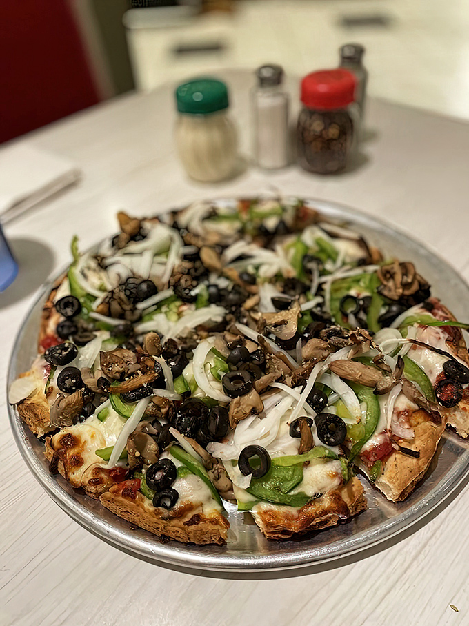 A veggie pizza that doesn't apologize for being healthy—a garden of toppings proving vegetarian options can be indulgent too.