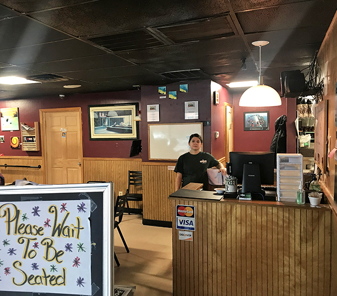 The welcoming counter where breakfast dreams begin. That "Please Wait To Be Seated" sign is just the first chapter of your meal story.