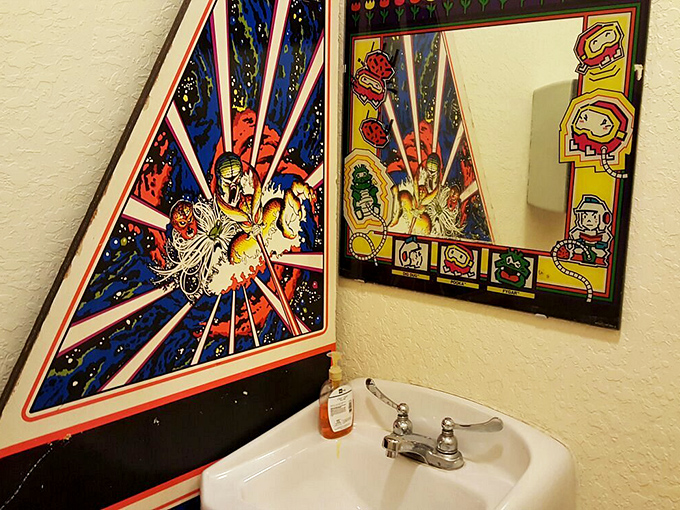 Even the restroom keeps the theme going! Where else can you wash your hands while contemplating vintage arcade art? Cleanliness with a side of nostalgia.