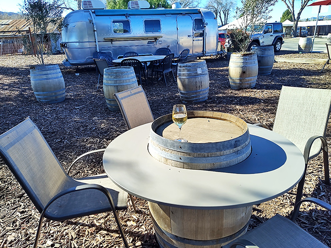 Wine barrel tables transform vineyard workhorses into rustic dining spots. That Airstream in the background is having serious FOMO.