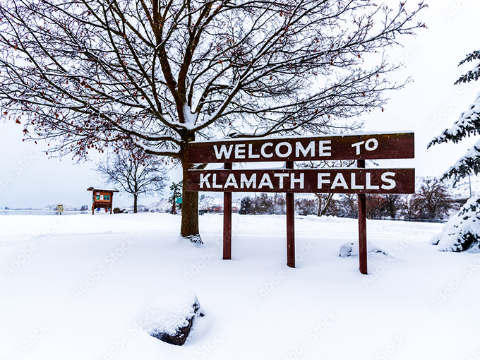 Winter transforms Klamath Falls into a serene wonderland where snow-covered welcome signs remind visitors that beauty here knows no season.