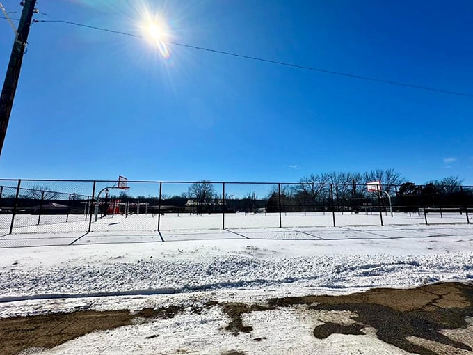 Winter transforms Pawhuska into a serene landscape of white, where even basketball courts become canvases for Oklahoma's seasonal beauty.