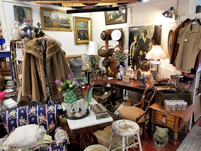 A perfectly staged vignette of elegance&mdash;fur coats, fine furniture, and framed portraits create a room that whispers stories of bygone sophistication.