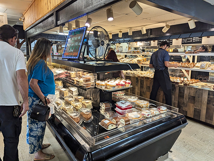 Bakery cases tempt shoppers with sweet rewards, proving that even bargain hunters need occasional indulgent pit stops.