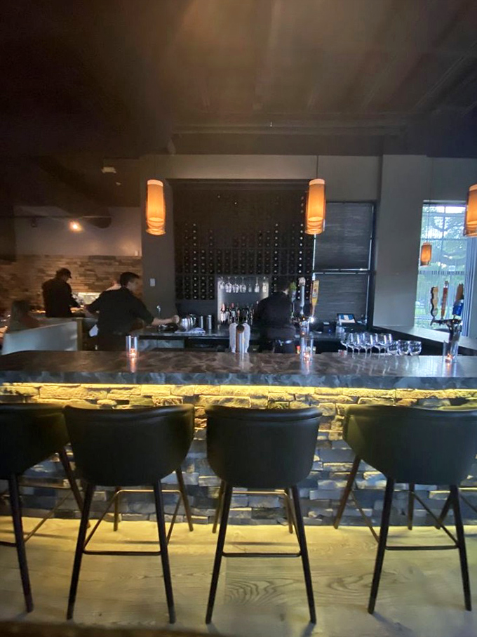 A bar that understands its mission: crafting liquid courage before you commit to ordering that 32-ounce tomahawk. The illuminated stone base adds drama worthy of your cocktail stories.