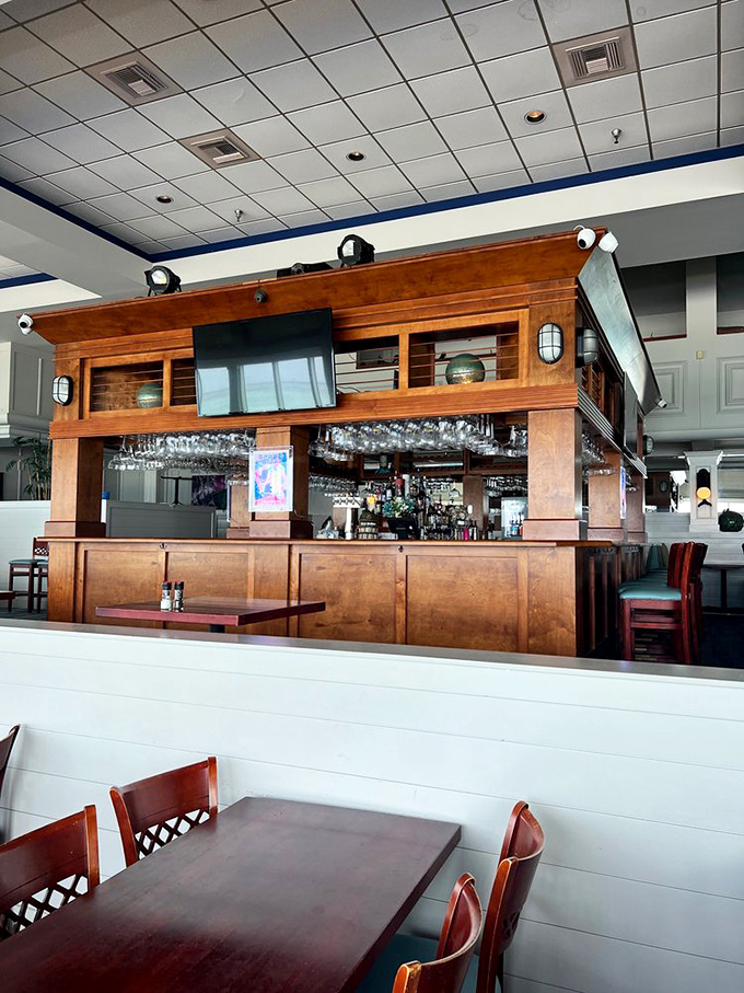 The bar stands ready for sunset toasts and vacation stories, with hanging glasses catching the afternoon light like crystal chandeliers.