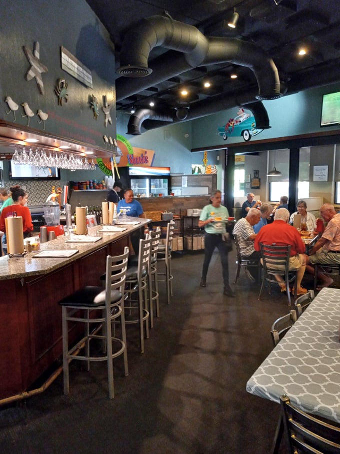 The bar area buzzes with locals and visitors alike, all united by the universal language of "pass the cocktail sauce, please."