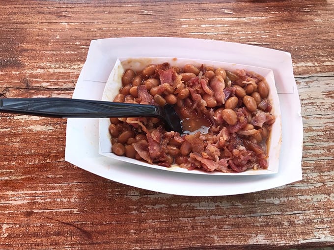 Baked beans with bacon bits&mdash;the unsung hero of the picnic table, bringing smoky sweetness to complement every hot dog adventure.