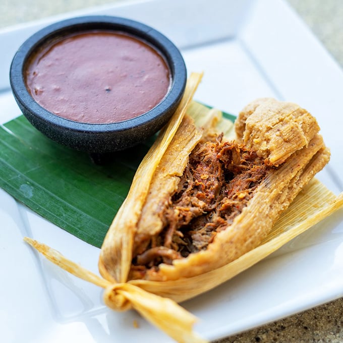 This tamale isn't just unwrapped&mdash;it's revealing its soul, tender shredded beef nestled in masa that's been steamed to cloud-like perfection.