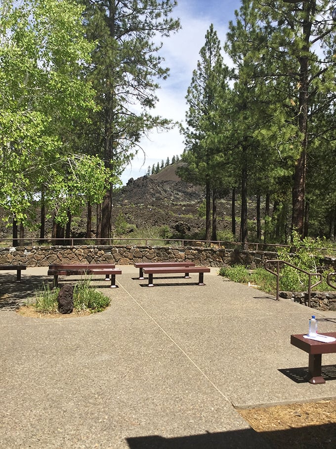 A peaceful rest area offers a moment to contemplate the volcanic landscape. These benches provide the perfect spot to catch your breath before or after your underground expedition.