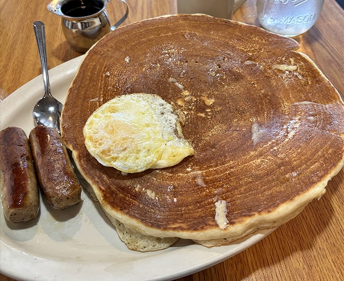 This pancake is so enormous it makes the sausage links look like breakfast appetizers&mdash;a plate that says "cancel your lunch plans."