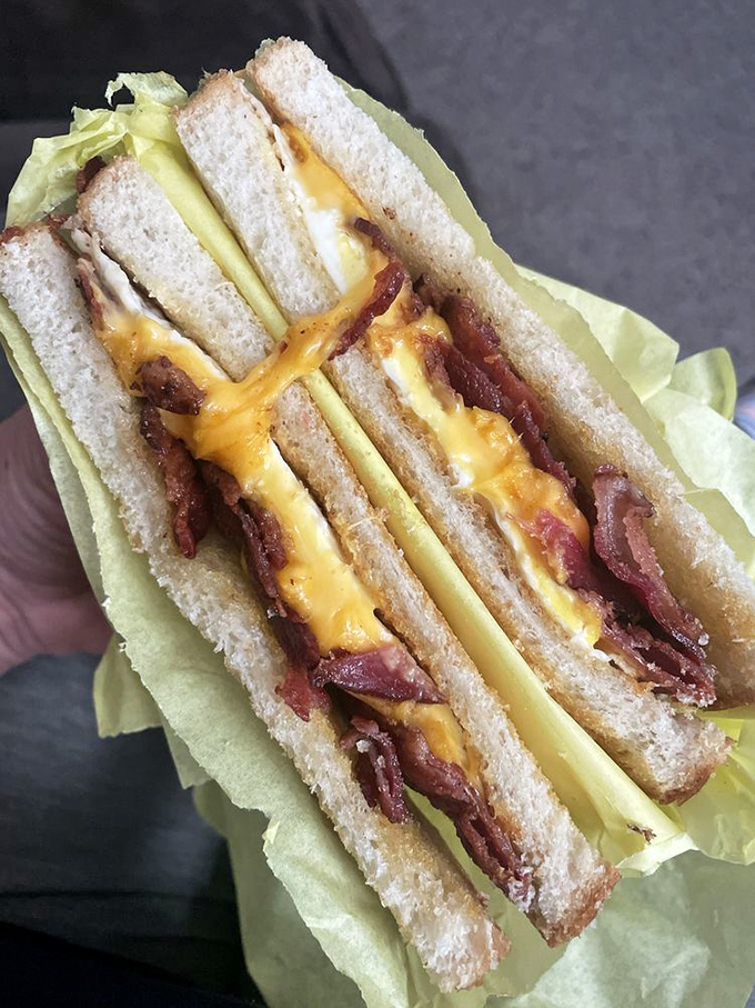 The breakfast sandwich trinity: bacon, egg, and cheese nestled between toast that's been buttered with precision and care.