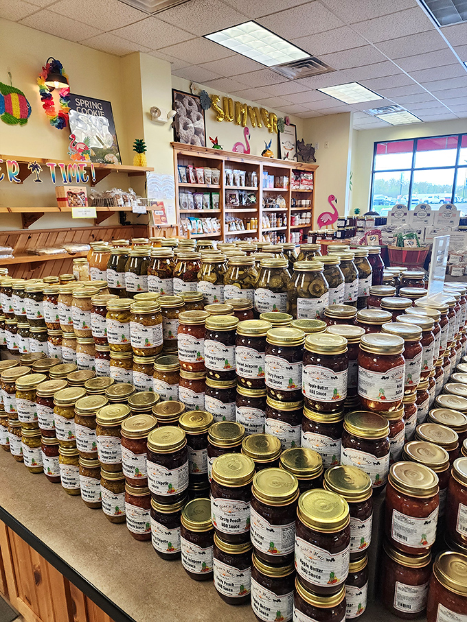 The jam display resembles a library of fruit preservation, where each jar tells a different story of summer captured in glass.