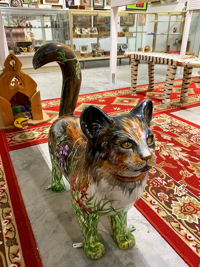 This painted cat figurine stands guard like a colorful sentinel, its tail raised high with the confidence of a creature that knows it rules.