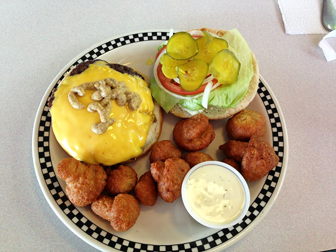 The universal language of "satisfaction" is written all over this plate. A burger, pickles, and evidence that someone was too hungry to wait for a photo.