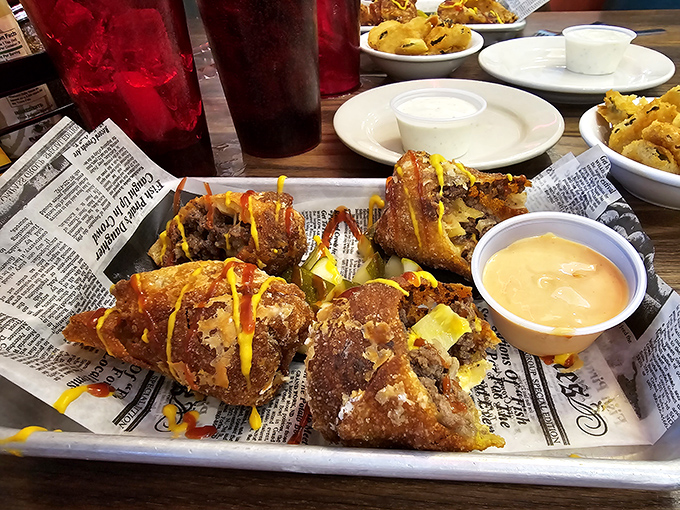 These aren't your ordinary appetizers&mdash;they're cheeseburger conspiracies wrapped in crispy packages, served on newspaper like delicious contraband.