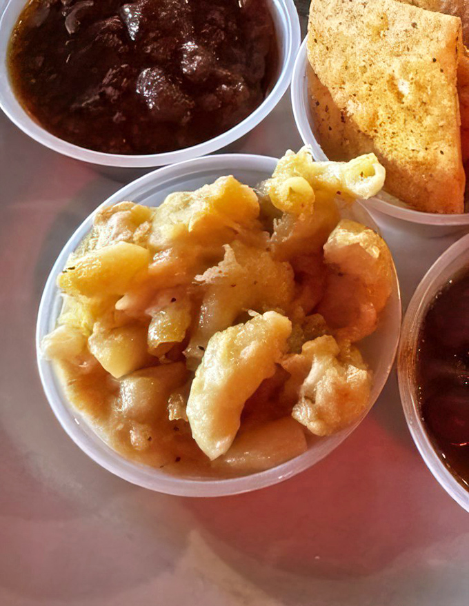 A holy trinity of comfort: golden mac and cheese, hearty chili, and cornbread that could make a Texan weep with joy.