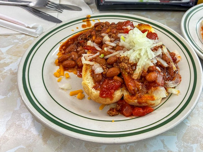 Chili so good it deserves its own zip code! This open-faced masterpiece topped with onions and cheese transforms a simple hot dog into a knife-and-fork affair.
