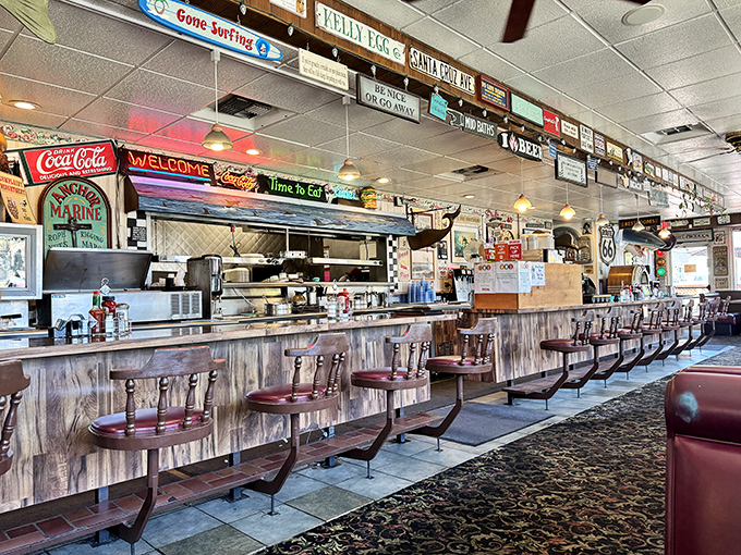 The counter where solo diners become regulars and servers perform the ballet of plates and coffee refills with practiced grace.