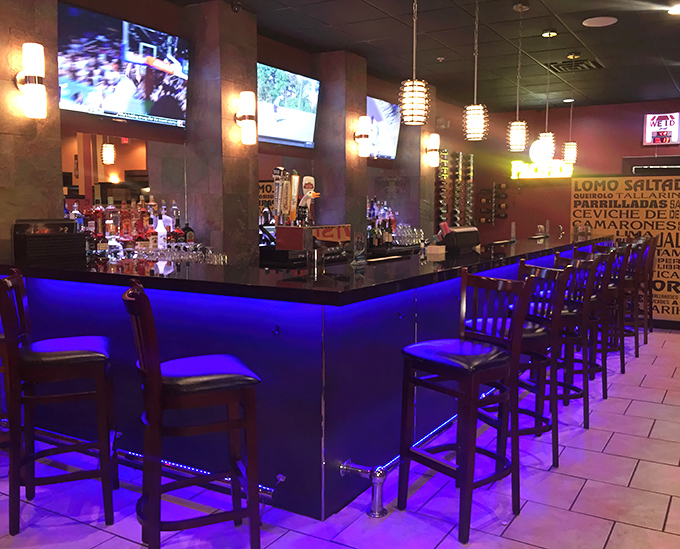 Blue-lit bar counters and multiple screens create a modern contrast to the traditional cuisine. Sports and ceviche &ndash; a winning combination.