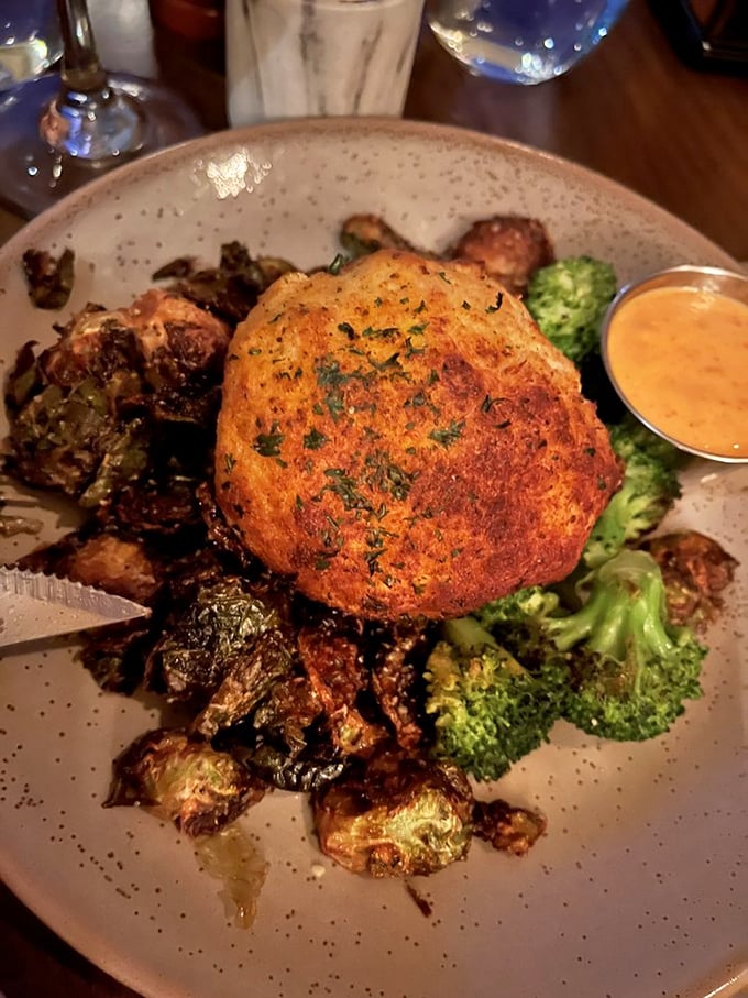 A crab cake that doesn't hide behind fillers. Perched atop roasted vegetables like royalty on a throne of deliciousness.