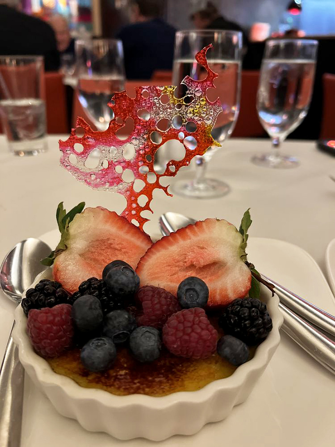 Not just cr&egrave;me br&ucirc;l&eacute;e but an entire berry festival celebrating on top. That sugar sculpture isn't showing off&mdash;okay, maybe a little.