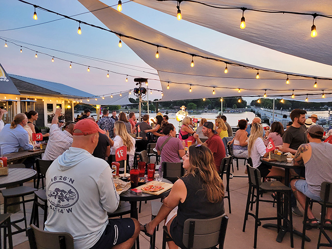 As twilight settles over Morse Reservoir, the patio transforms into a community gathering spot where food, drinks, and laughter flow freely.