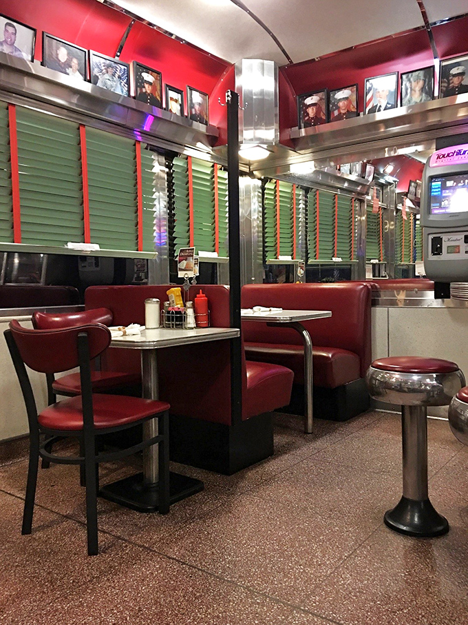 Red booths that have probably heard more town gossip than the local barber shop. Classic diner design that says "stay awhile, order dessert."
