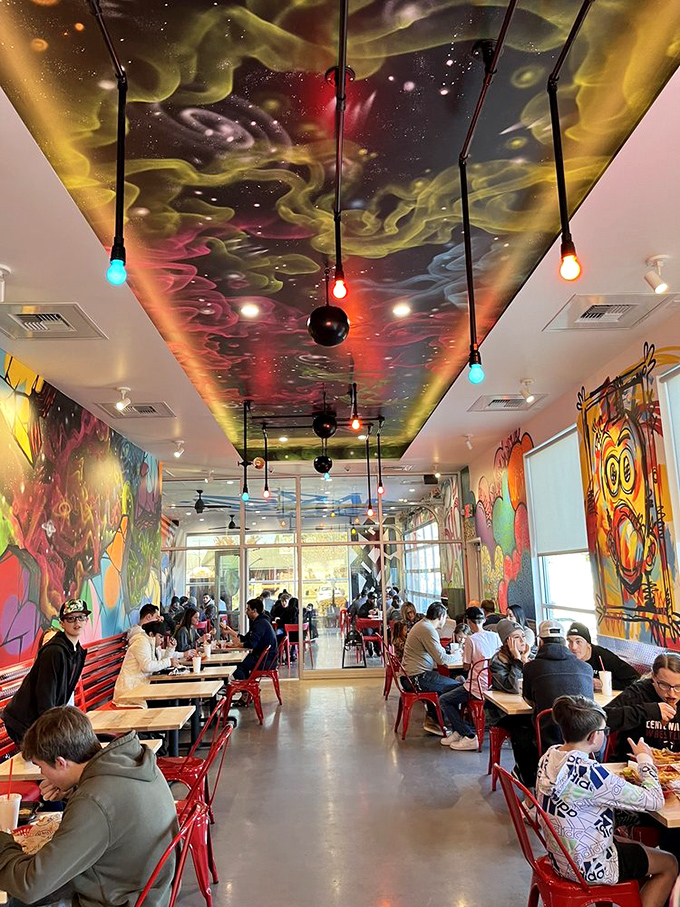 The dining room buzzes with the energy of happy eaters under a cosmic ceiling that's almost as mind-blowing as the chicken itself.