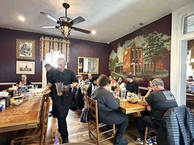 The server navigates between tables with the grace of a NASCAR driver, delivering Southern classics to eager diners who've abandoned all pretense of moderation.