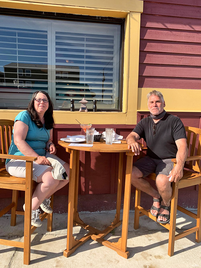 Outdoor dining with a view of Carolina Beach's charm&mdash;where conversations flow as easily as the cocktails.