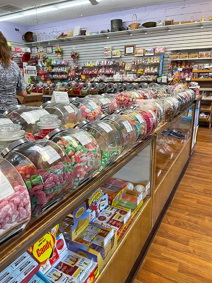 The candy counter stretches on like a sweet horizon, with glass jars protecting treasures more valuable than gold to anyone with a sweet tooth.